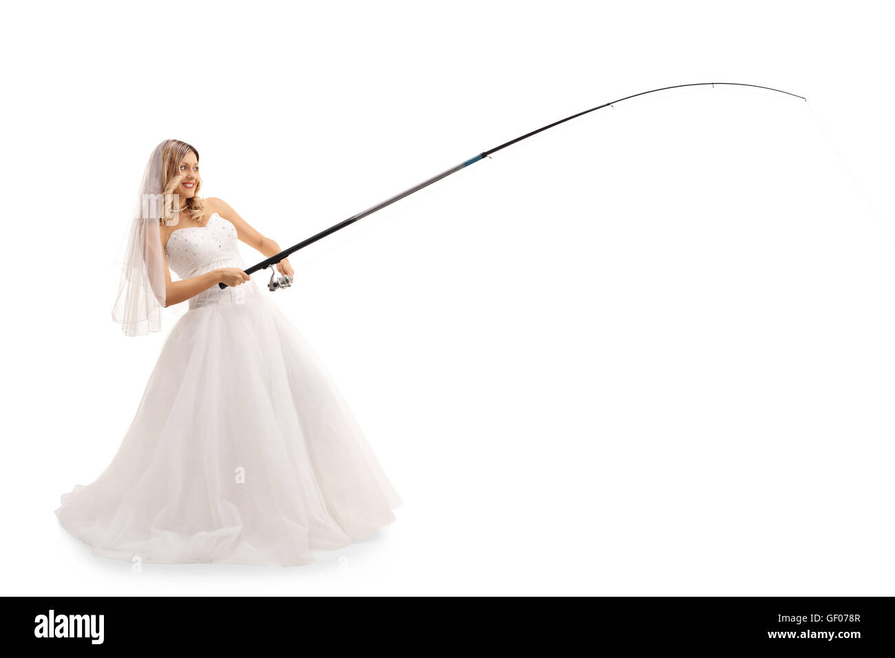 Young joyful bride in a wedding dress fishing with a rod isolated on ...