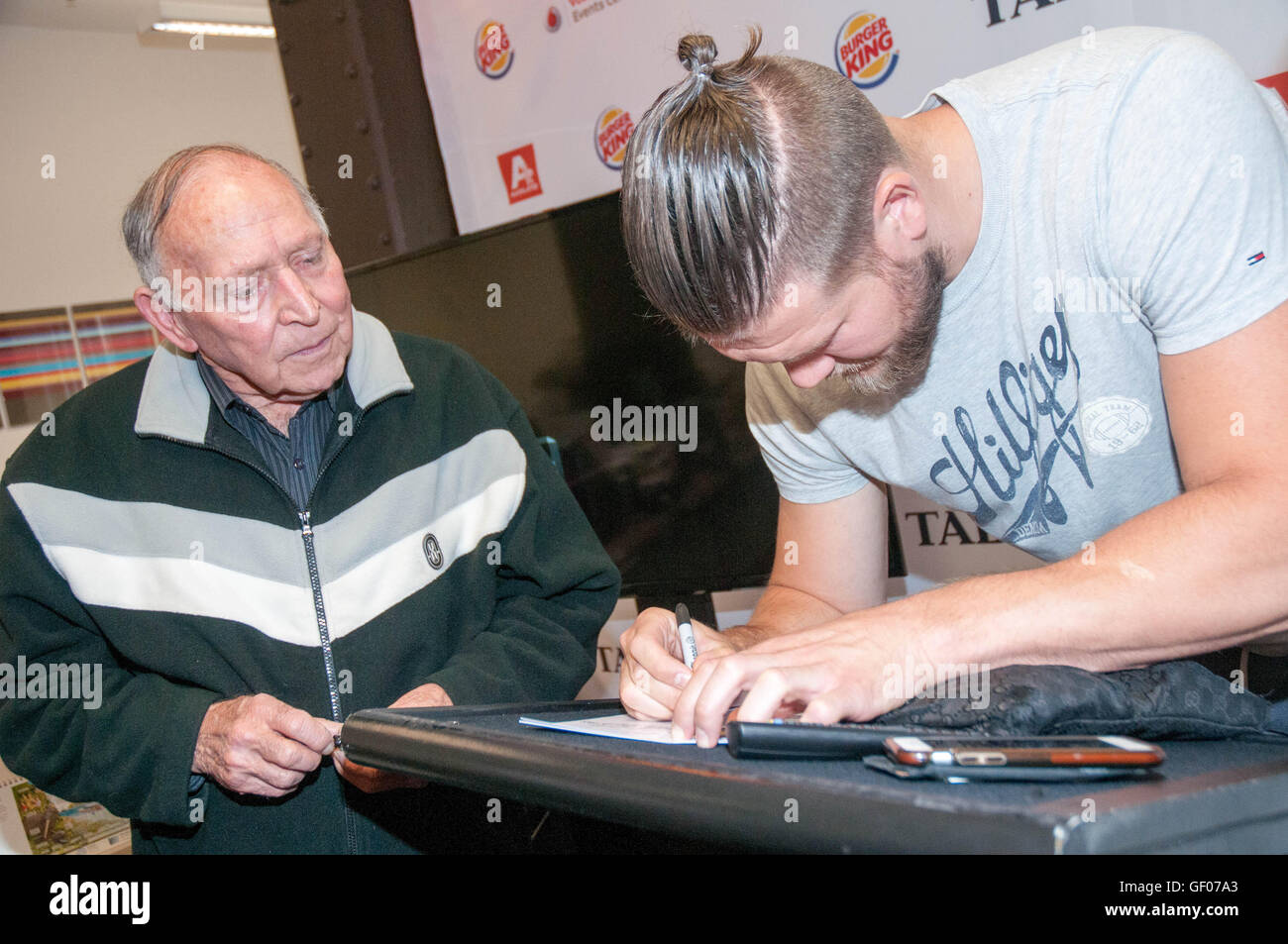 Russian heavyweight boxer Alexander Dimitrenko signs autography to fans ...