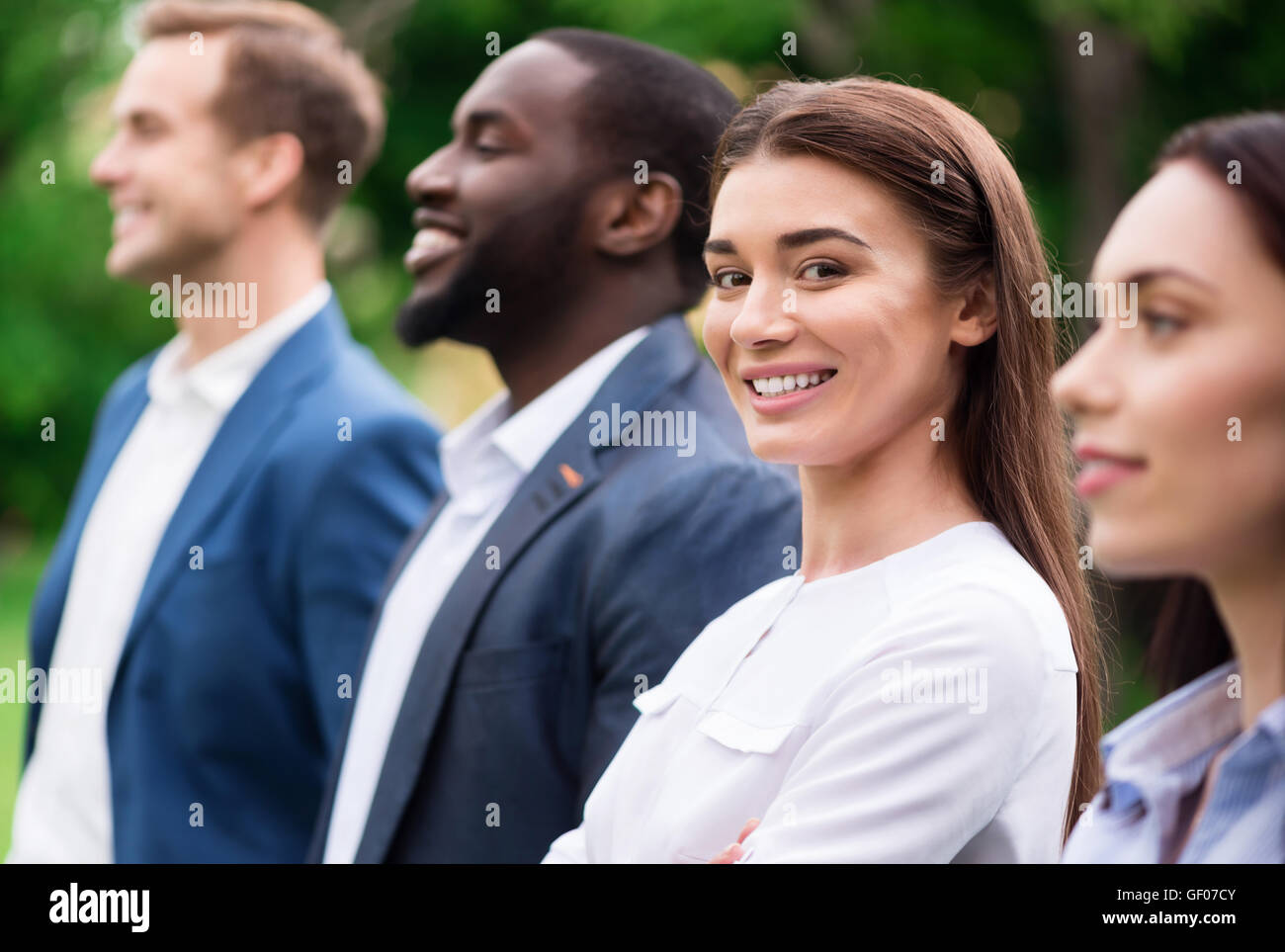 Smiling colleagues standing outside Stock Photo - Alamy