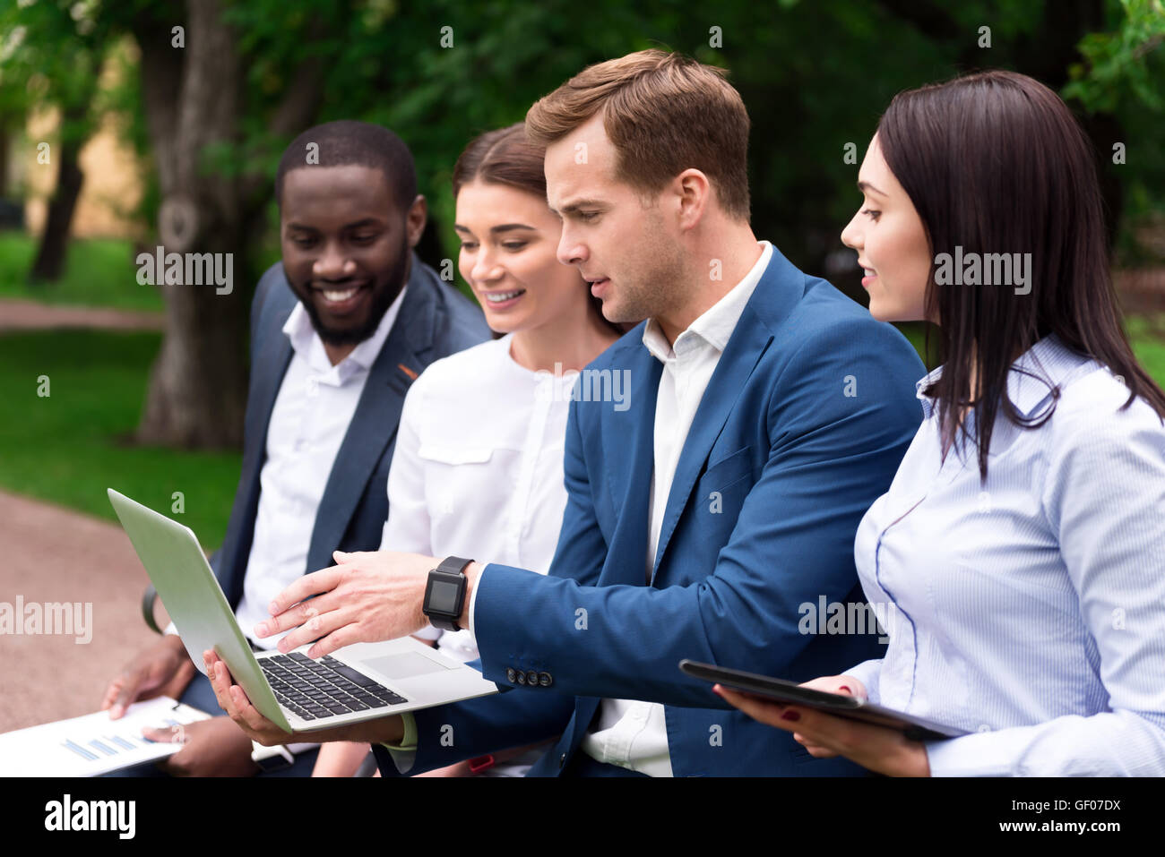 Positive involved colleagues working outside Stock Photo - Alamy