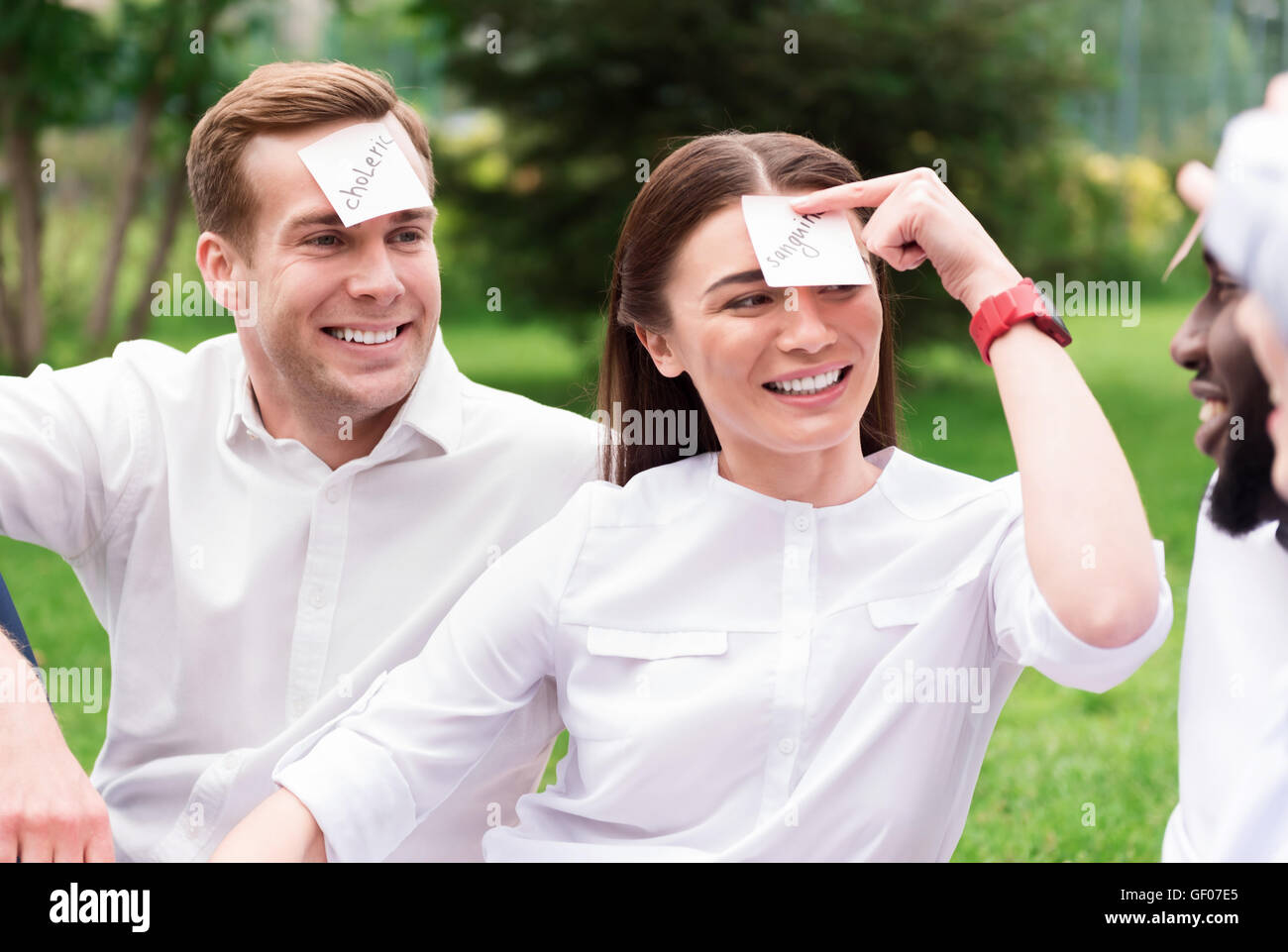Joyful smiling friends having fun on the grass Stock Photo - Alamy
