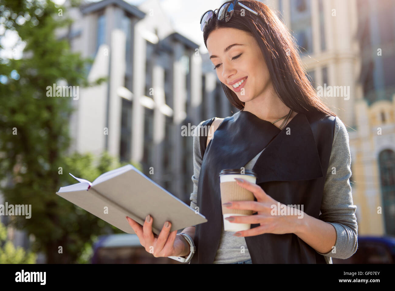 Positive woman reading book Stock Photo - Alamy