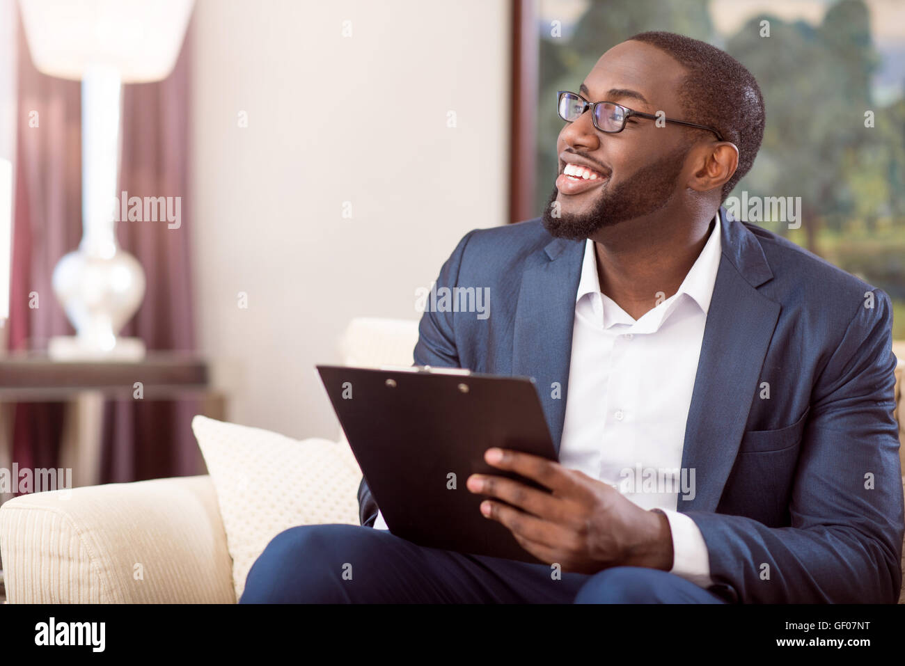 Man in suit noting down information Stock Photo - Alamy