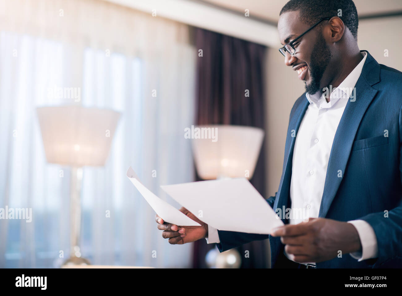 Afro American man holding documents Stock Photo - Alamy