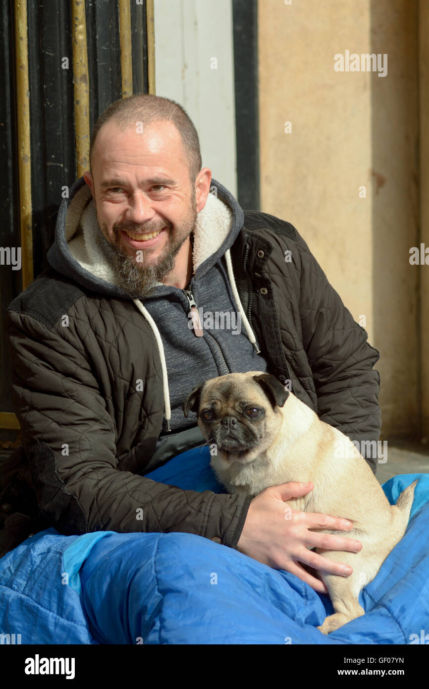 Homeless man portrait with his pet pug dog in Cambridge, England Stock ...