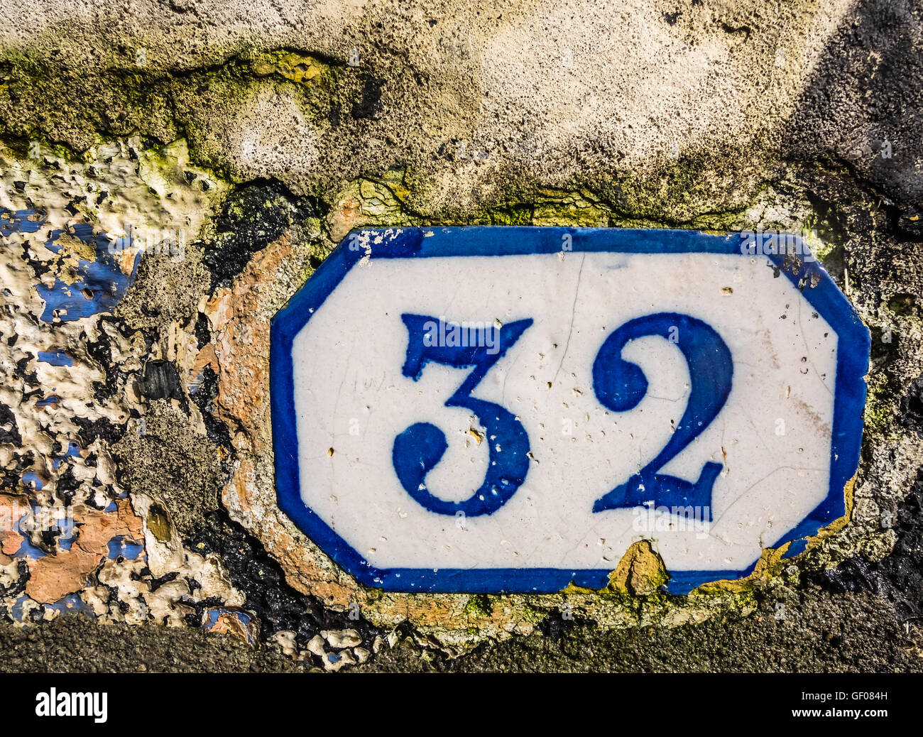 Old door plaque with the number 32 on a wall of an old home Stock Photo ...