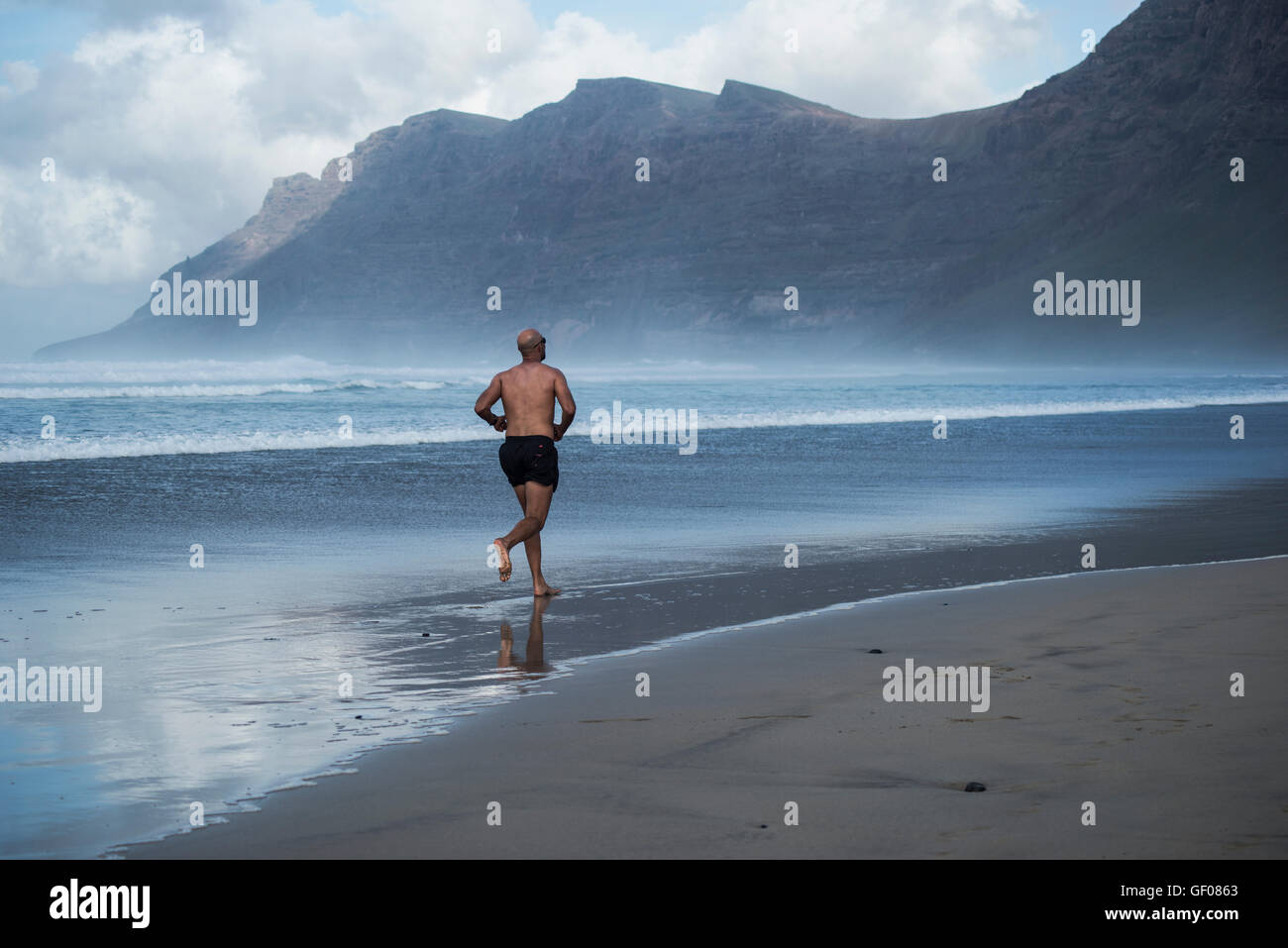 Man running beach hi-res stock photography and images - Alamy
