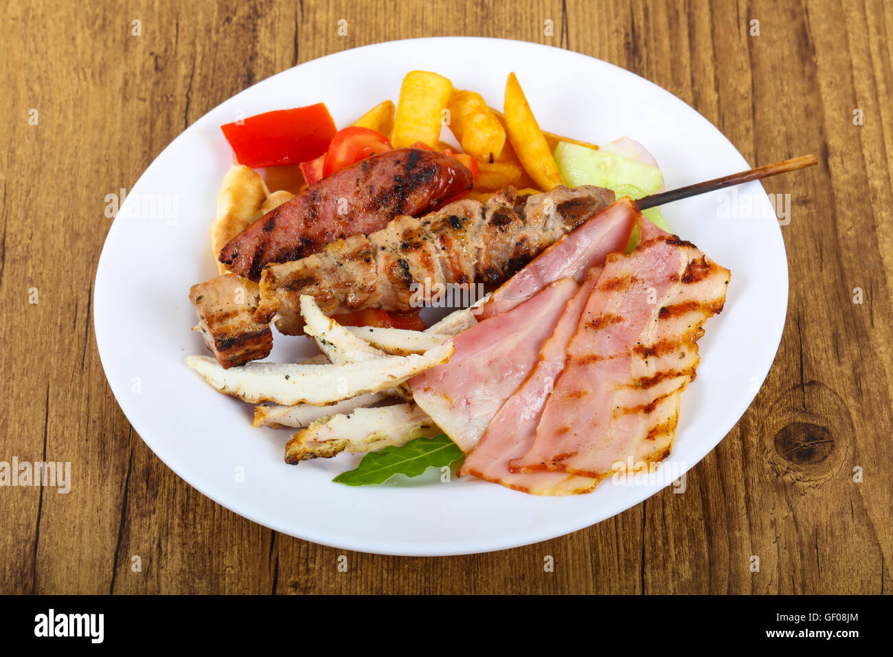 Grill meat mix with potato and tomato Stock Photo - Alamy