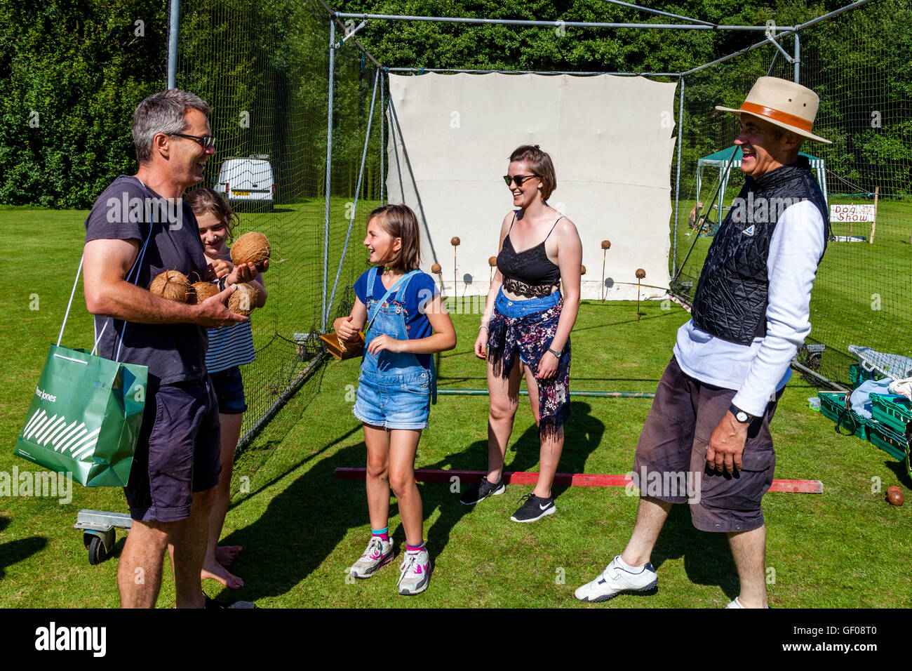 A Family Win Several Coconuts After Playing On The Coconut Shy ...