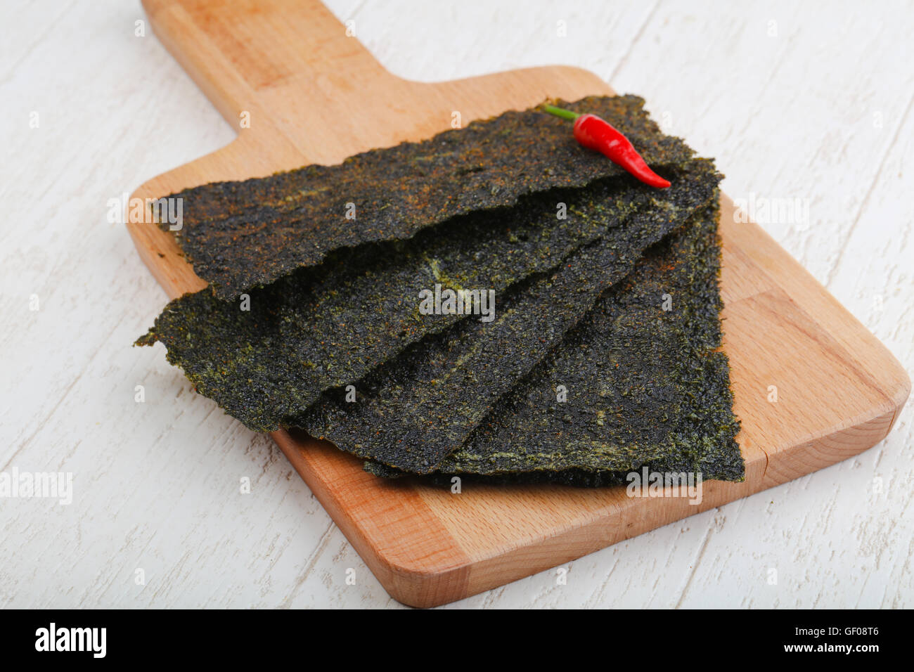 Spicy Nori seaweed sheets with pepper on wood Stock Photo - Alamy