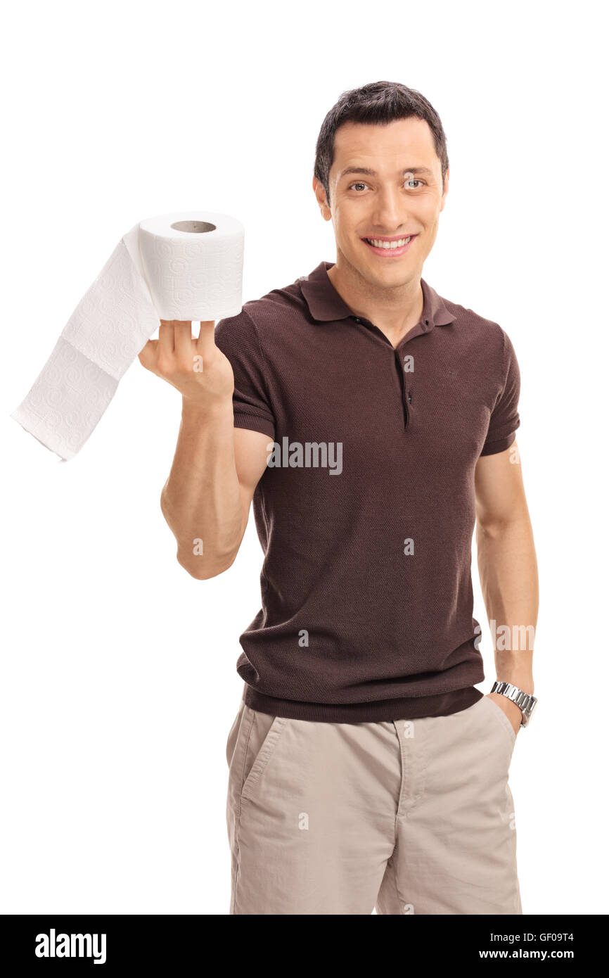 Vertical shot of a cheerful young guy holding a roll of toilet paper ...