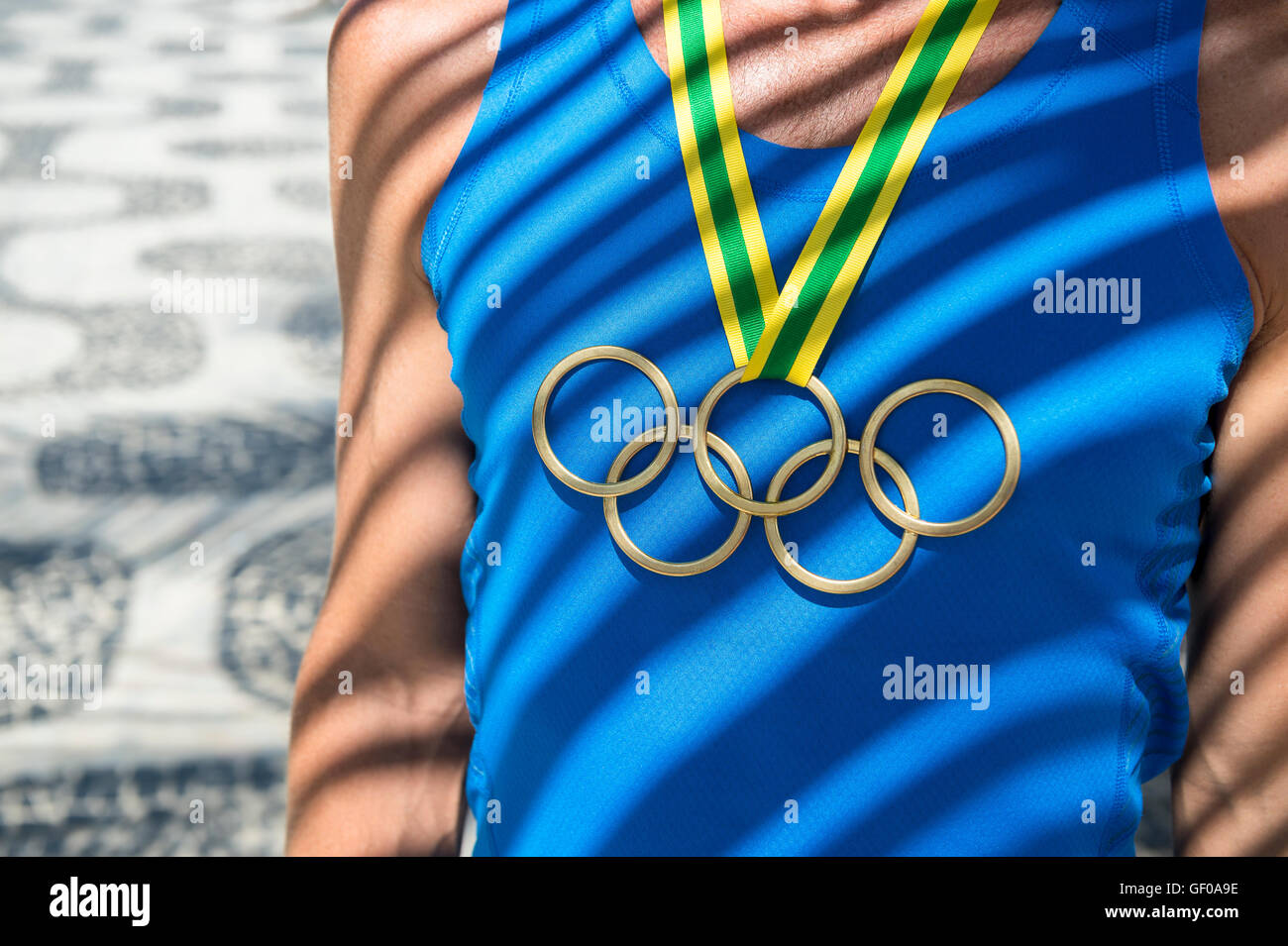RIO DE JANEIRO - FEBRUARY 23, 2015: Athlete wearing Olympic rings gold ...