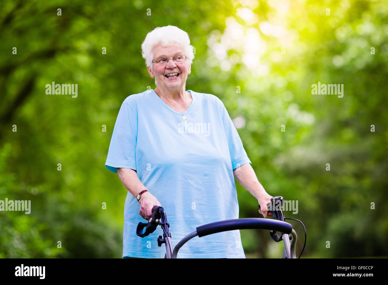 Happy senior handicapped lady with a walking disability enjoying a walk ...