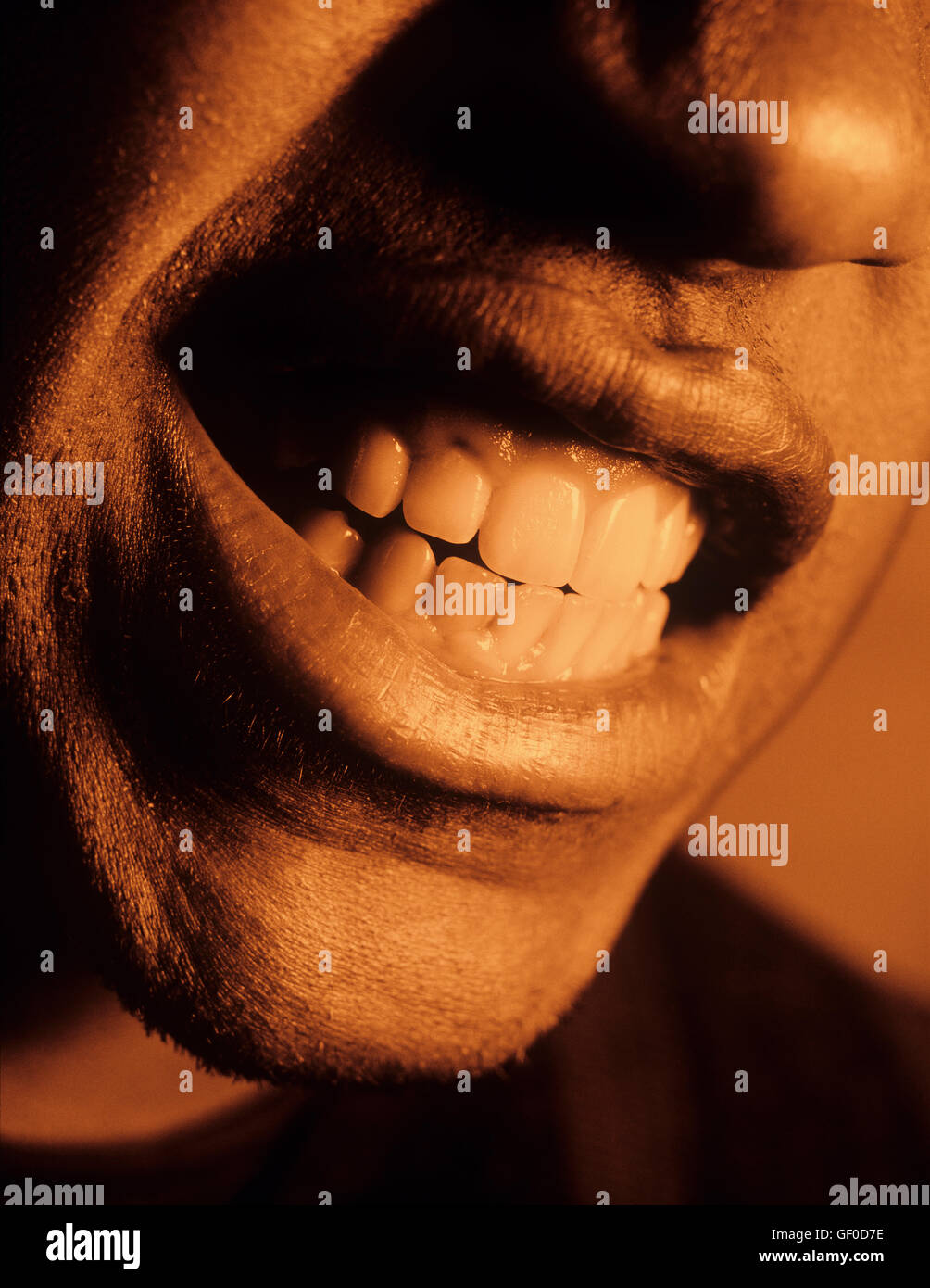 Closeup of a man cringing his teeth in disgust in monochromatic Stock ...