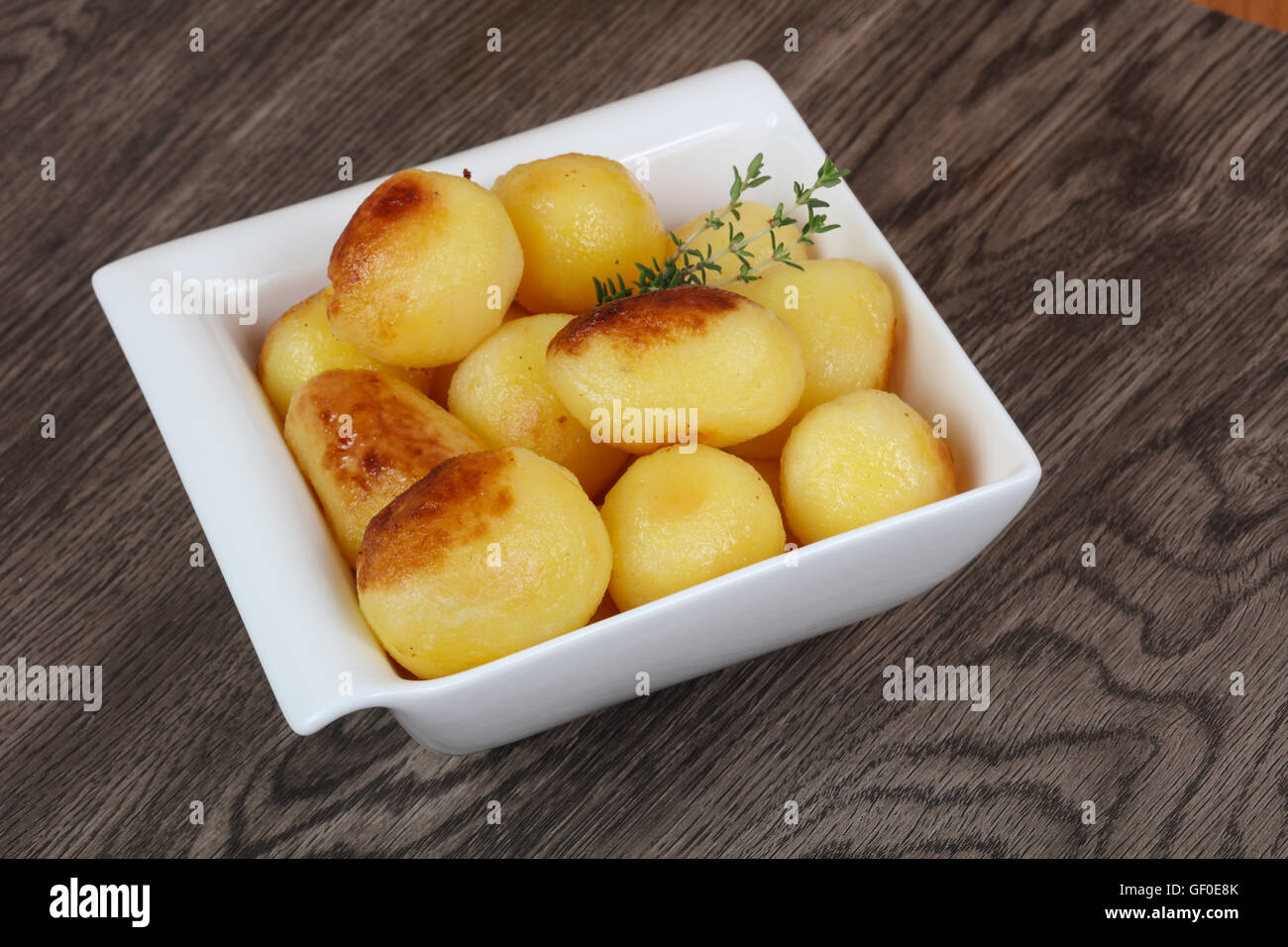 Golden backed potato with thyme branch Stock Photo - Alamy