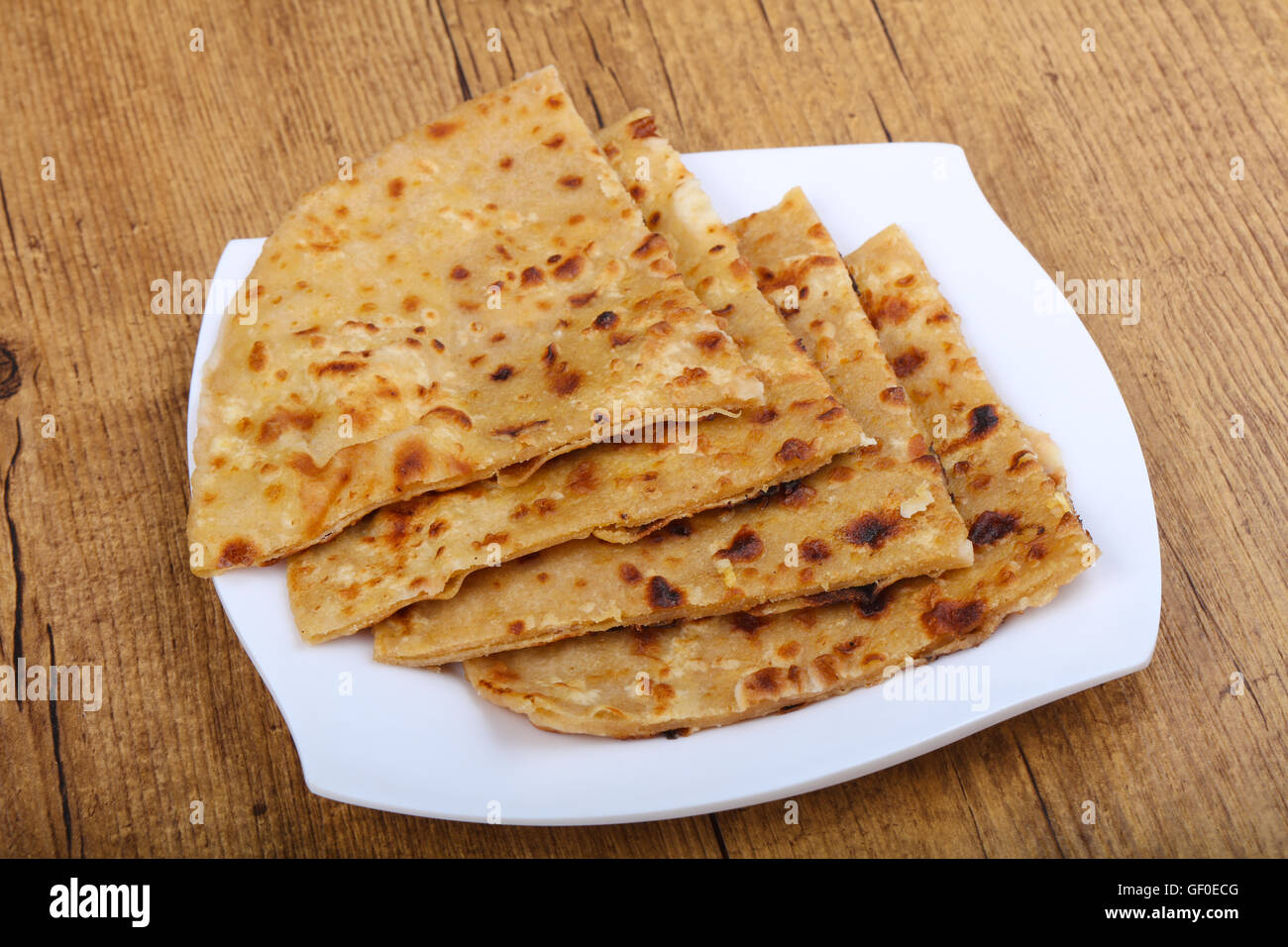 Indian bread roti on the plate in wood background Stock Photo - Alamy