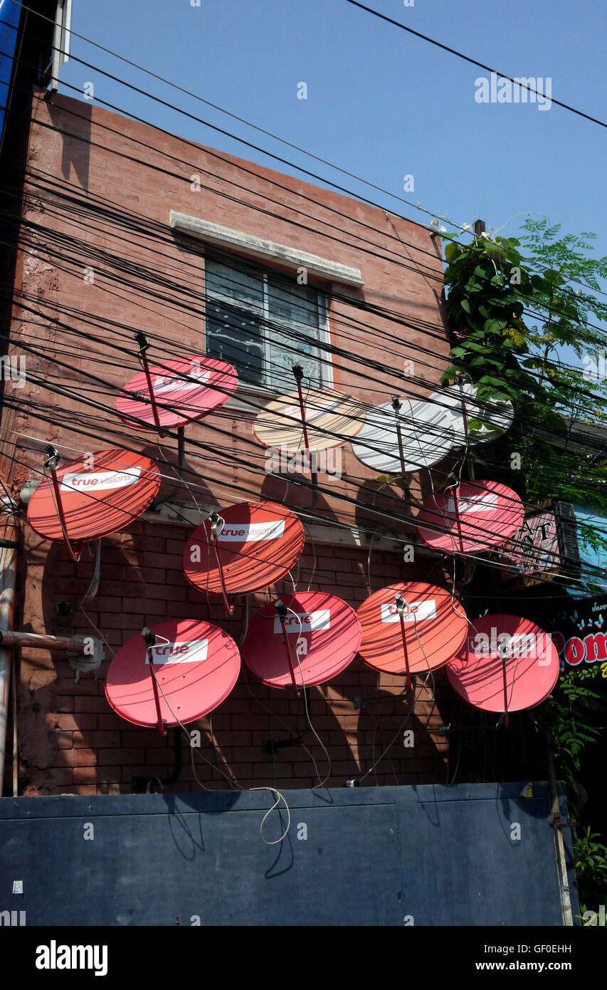 A tight group of Satellite dishes outside an apartment surrounded by ...