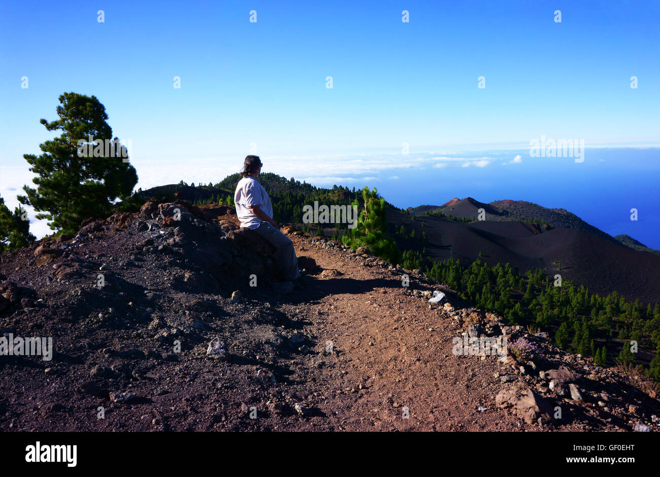 Hiker on Routa de los volcanes, Volcanoes hiking trail, far back Martin ...