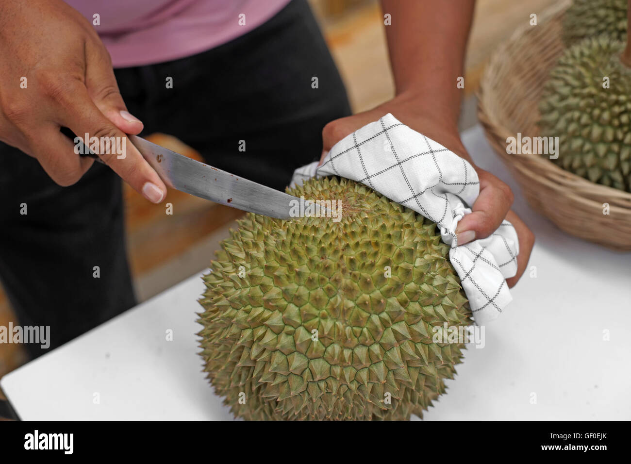 vendor peeling durian for customer in fruit market Stock Photo - Alamy