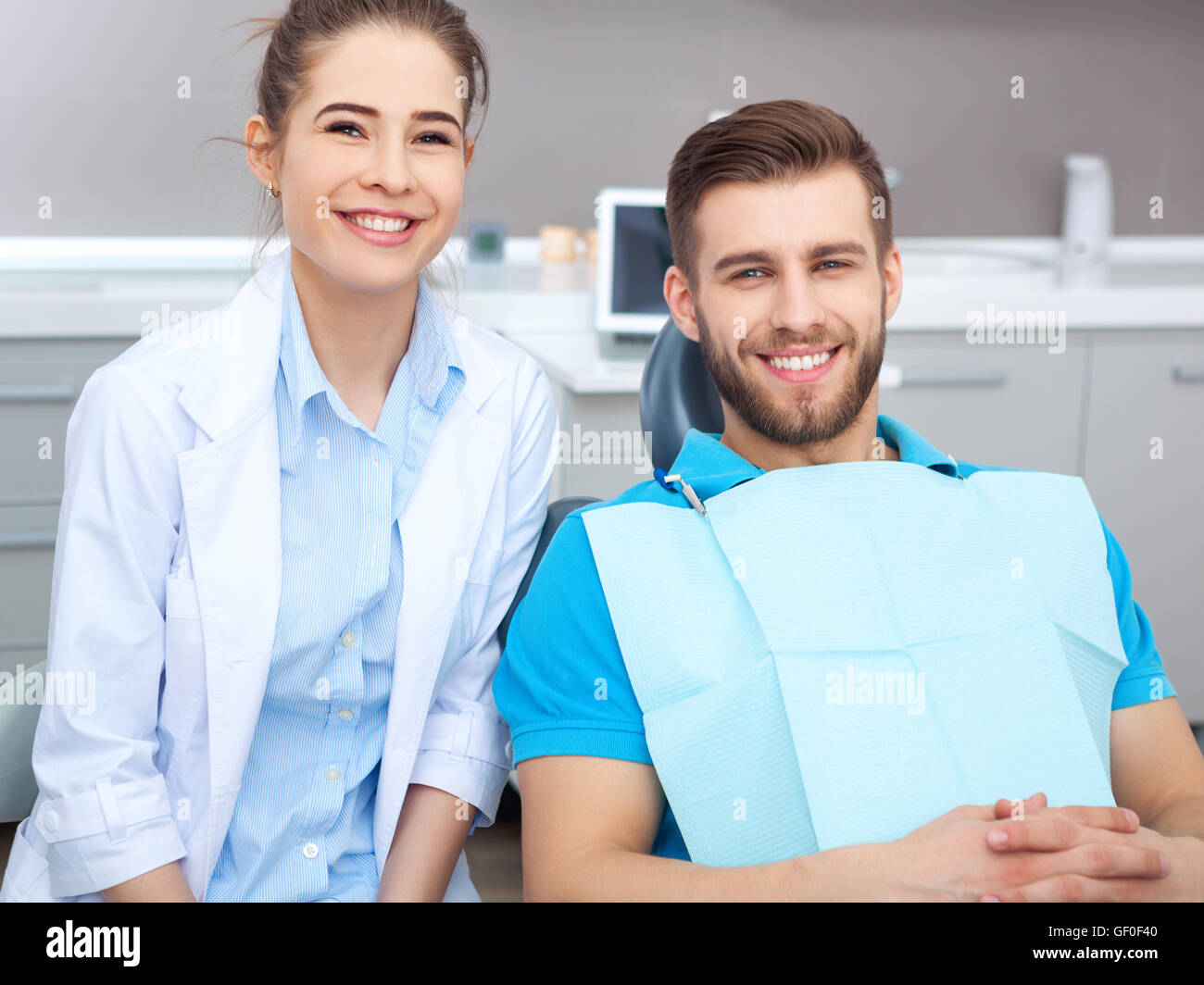 My dentist is the best! Portrait of a female dentist and young man in a ...