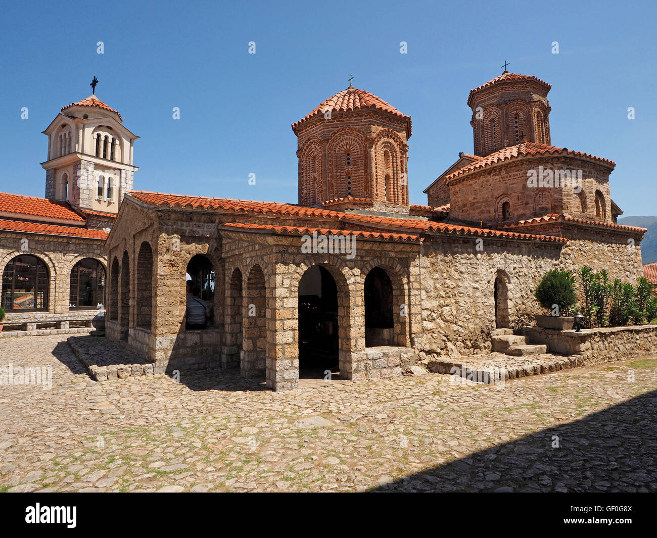 Cobbled courtyard & stone buildings with tiled towers & domes of ...