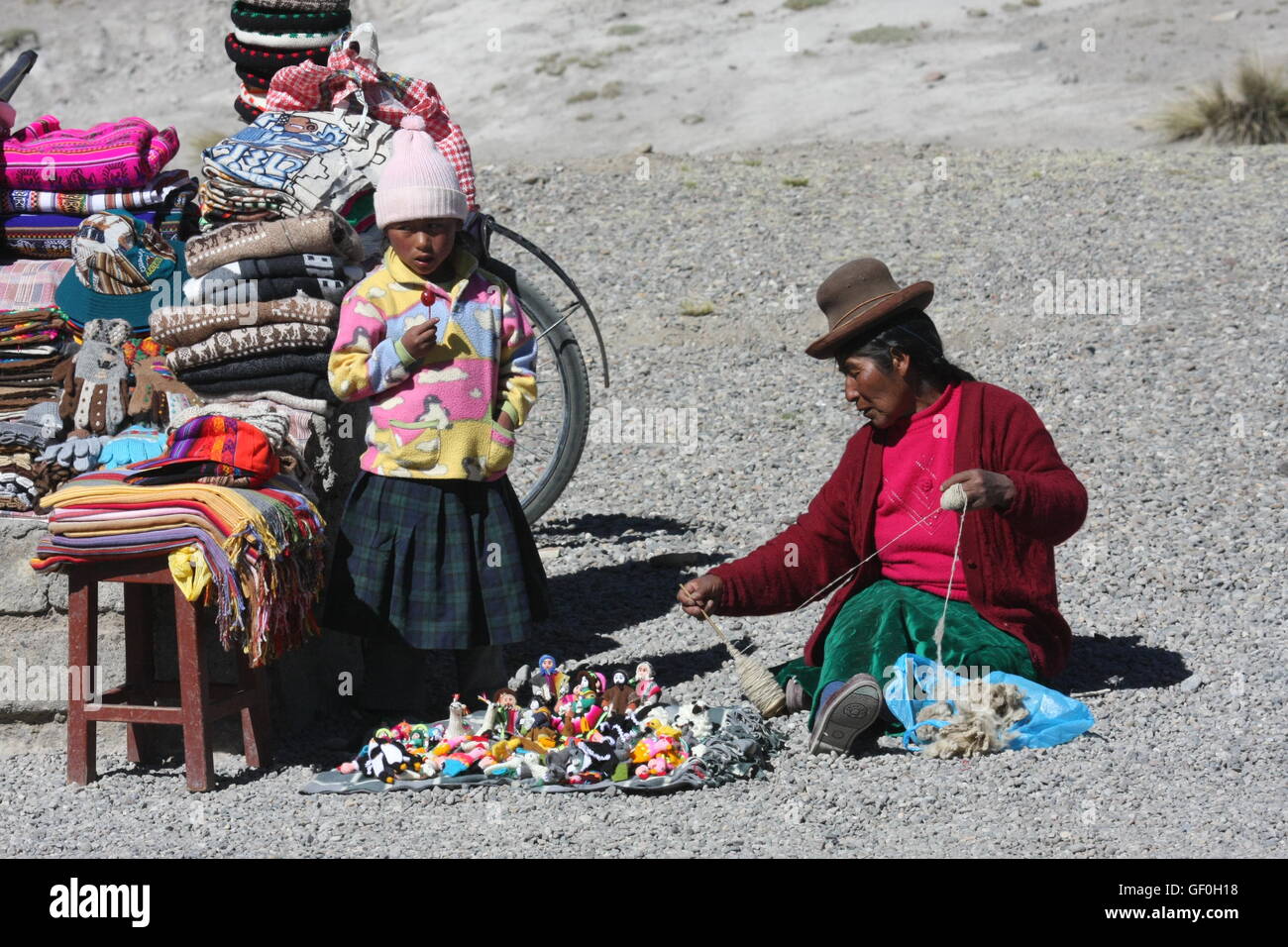 Peruvian woman and child selling hand made woollen items on the Andean ...