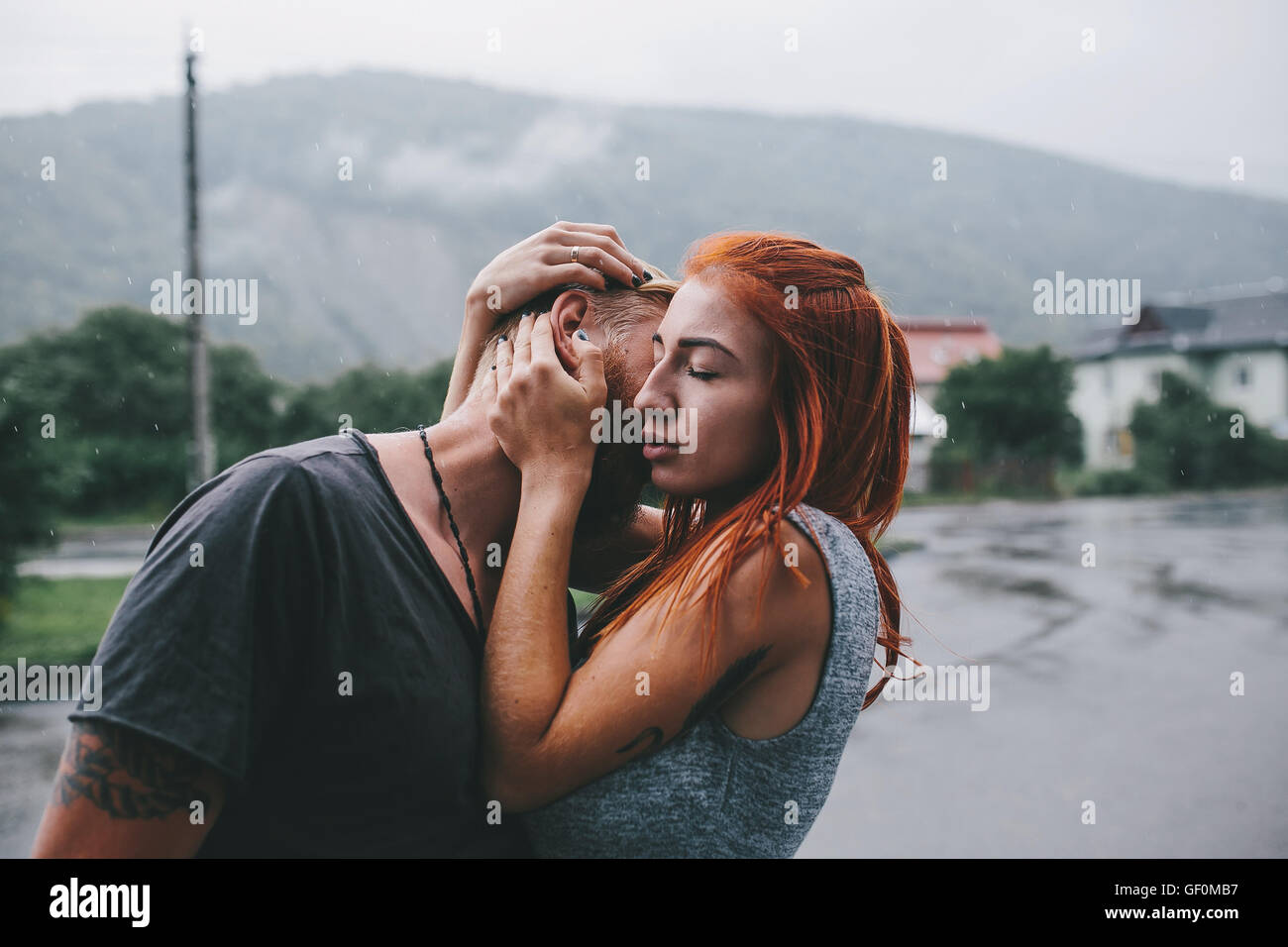 beautiful couple hugging in the rain Stock Photo - Alamy
