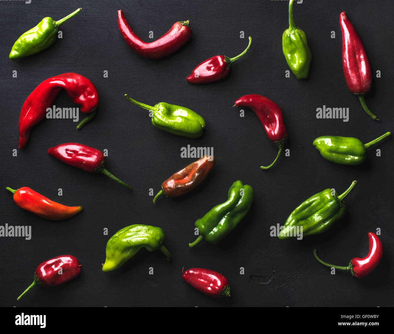 Pattern of small colorful hot chili peppers on black background Stock ...