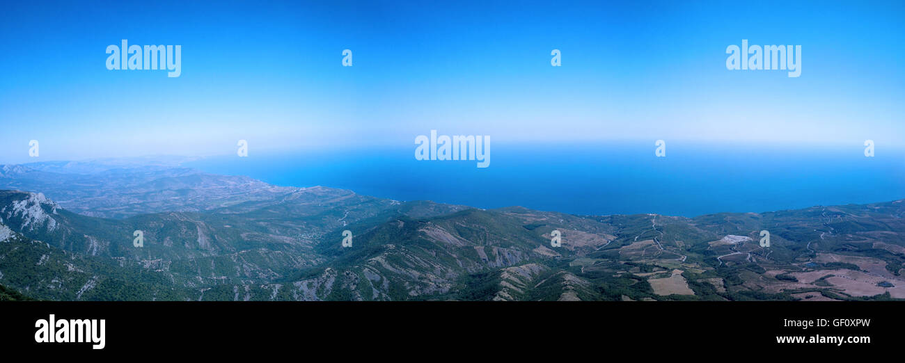 Strong wind on top of mountain overhanging sea. Camera is pulling wind ...