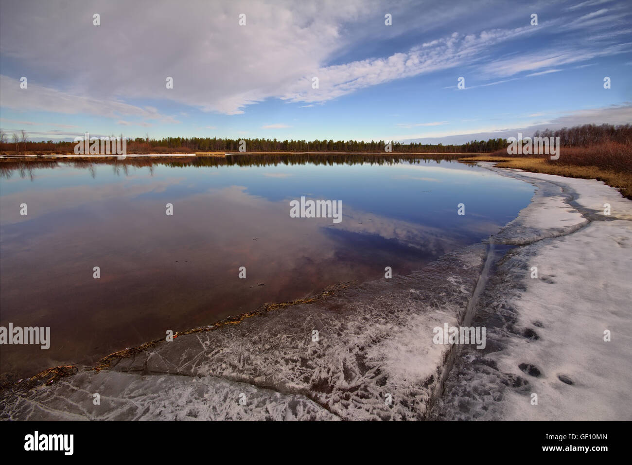 melt pond with water taken from a low point. Near snow Stock Photo - Alamy
