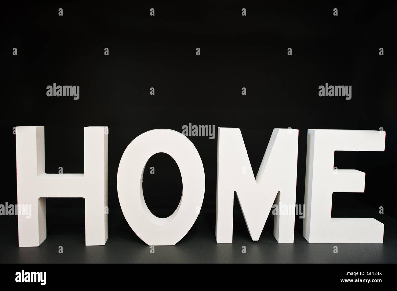 White wooden letters HOME at black background Stock Photo - Alamy