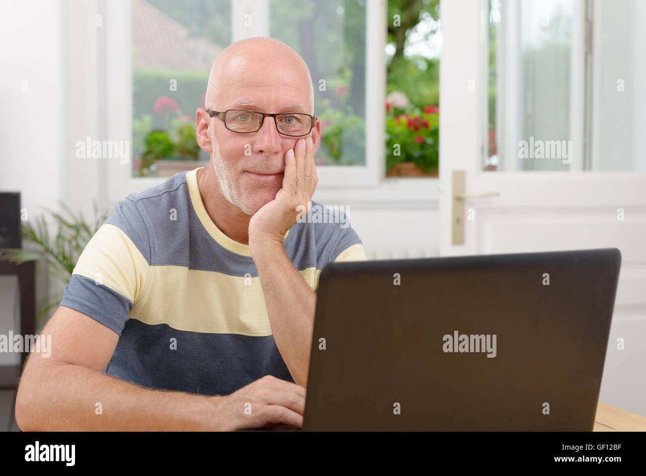 a middle-aged man with a laptop Stock Photo - Alamy