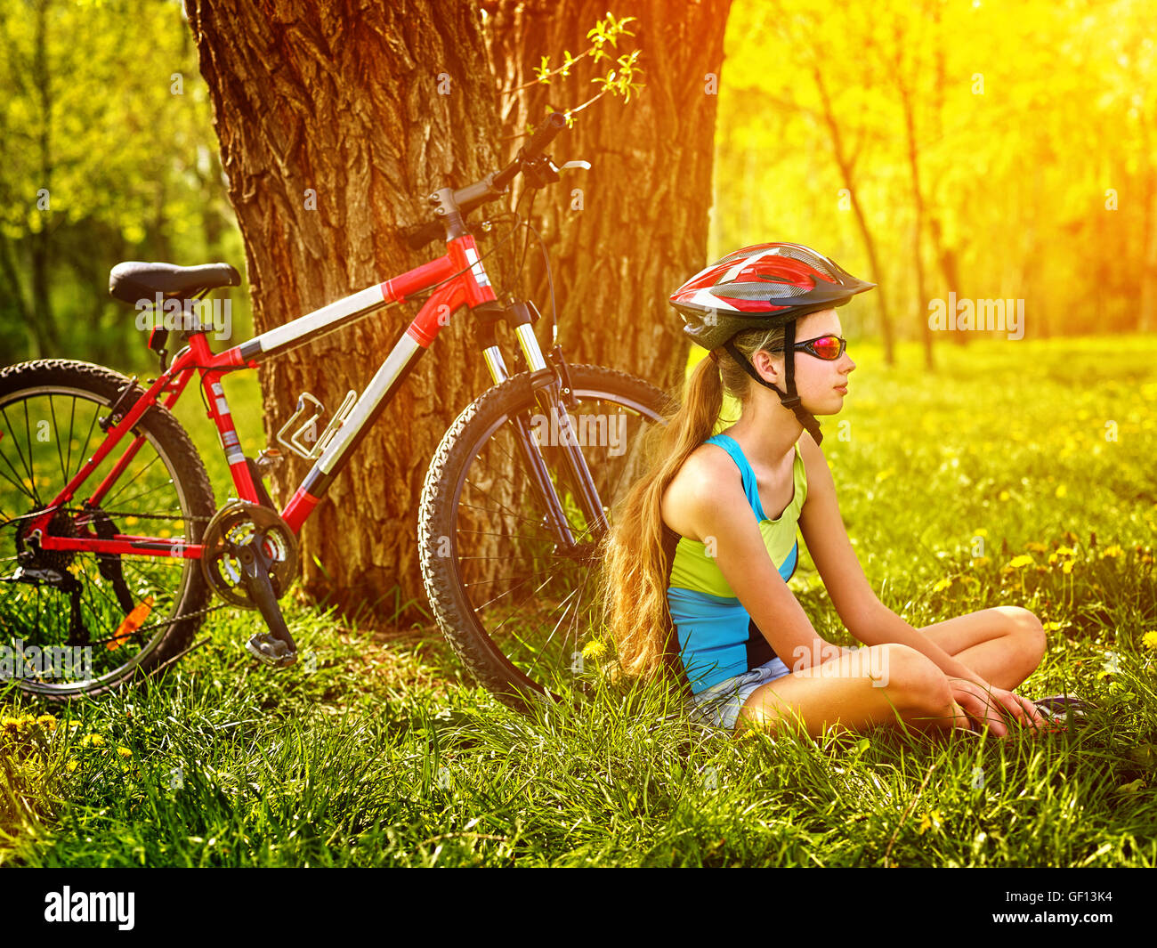 Bikes cycling girl wearing helmet have rest sitting under tree Stock ...