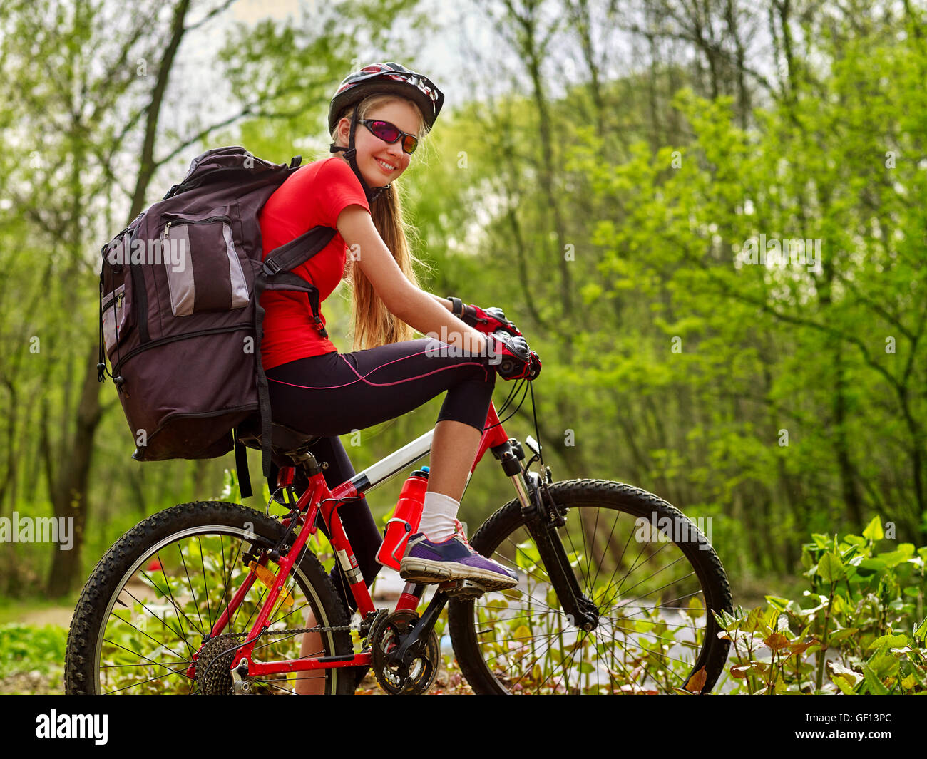 Girl rides bicycle on green grass in park outdoor Stock Photo - Alamy