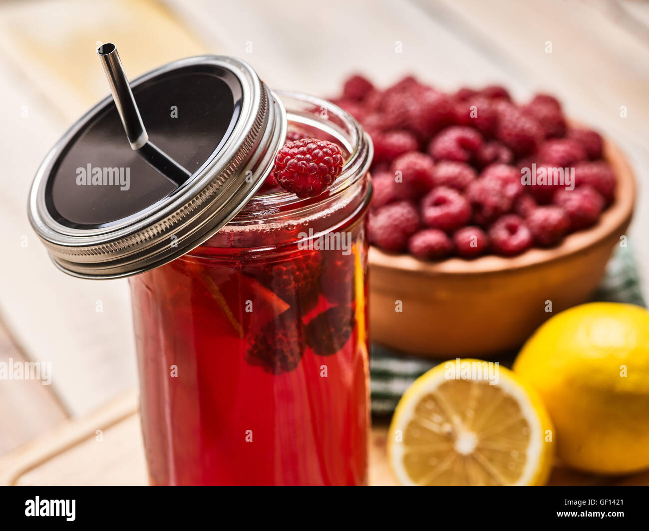 Ice cold drink glass with raspberry and lemon cocktail Stock Photo - Alamy