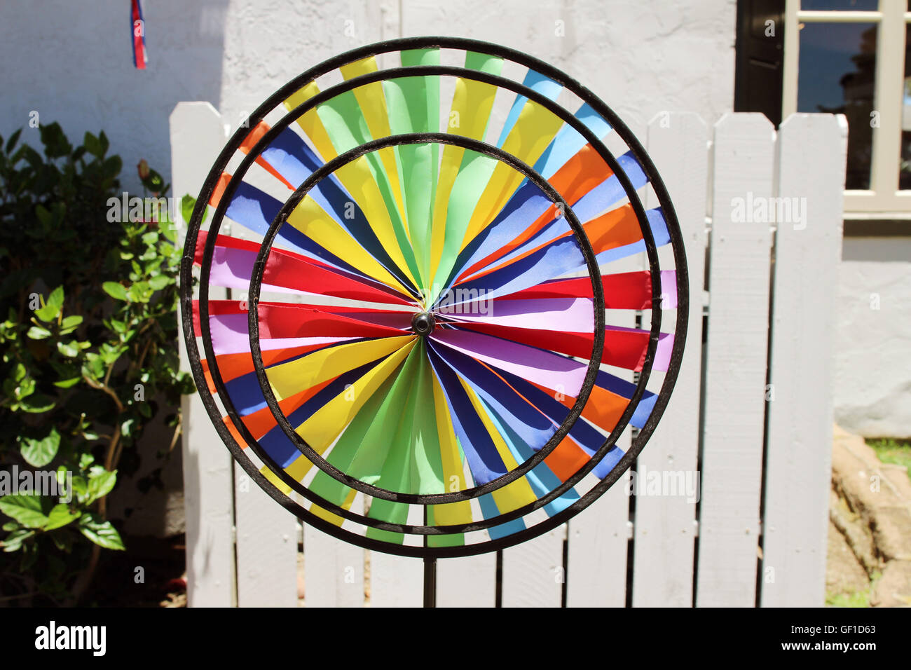 A colorful triple wheel wind spinner Stock Photo - Alamy
