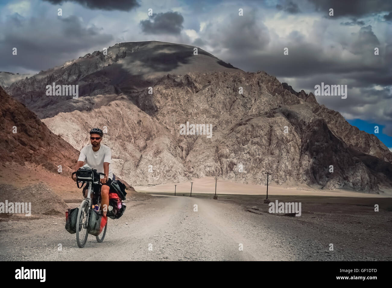 Solo male cycle touring through the stunning remote landscape of ...