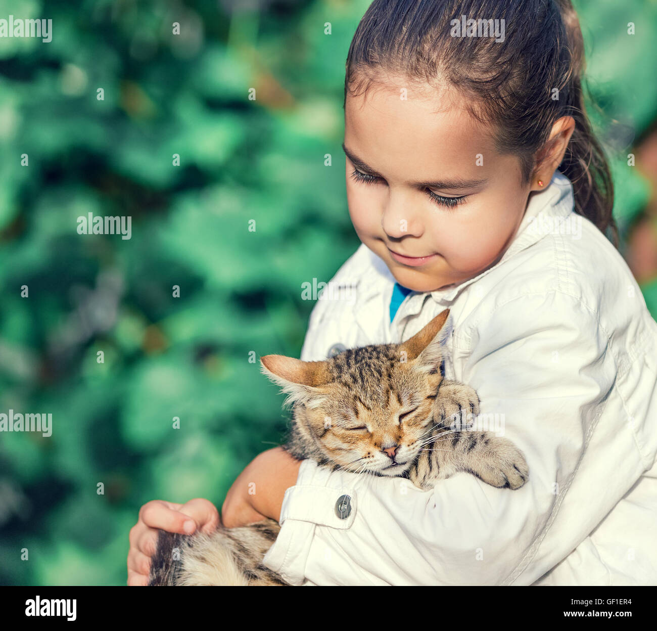 Cute sad girl hugging a cat in the garden Stock Photo - Alamy