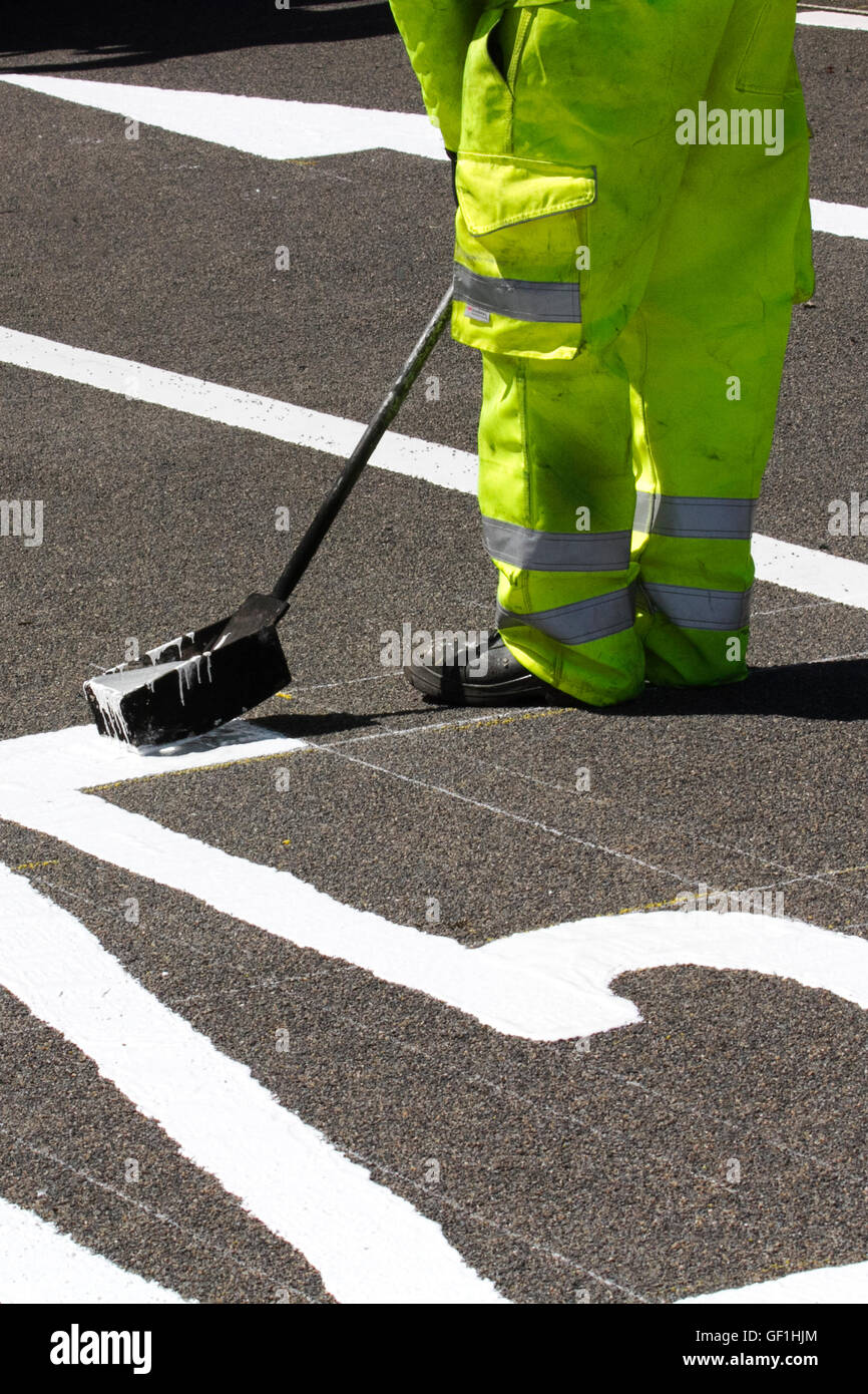 City Council maintenance roadworkers paint white lines on streets ...