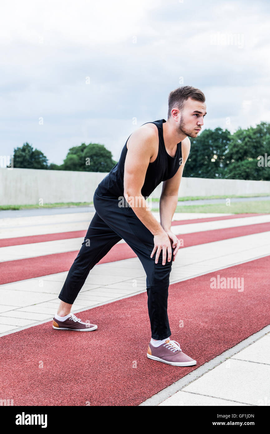Young athlete in black sports clothing preparing for training or for ...