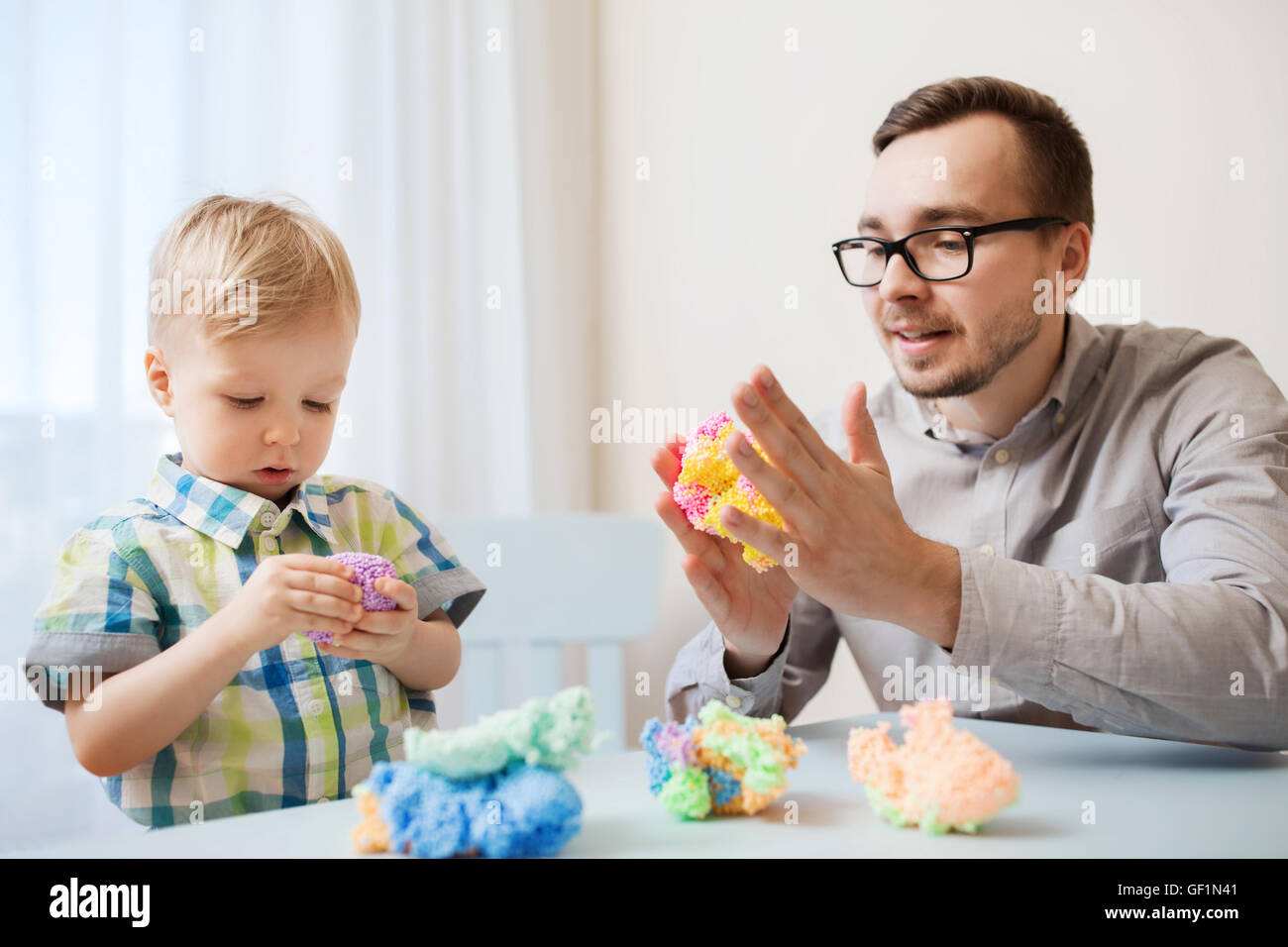 father and son playing with ball clay at home Stock Photo - Alamy