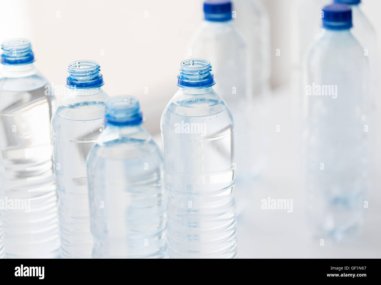 close up of bottles with drinking water on table Stock Photo - Alamy