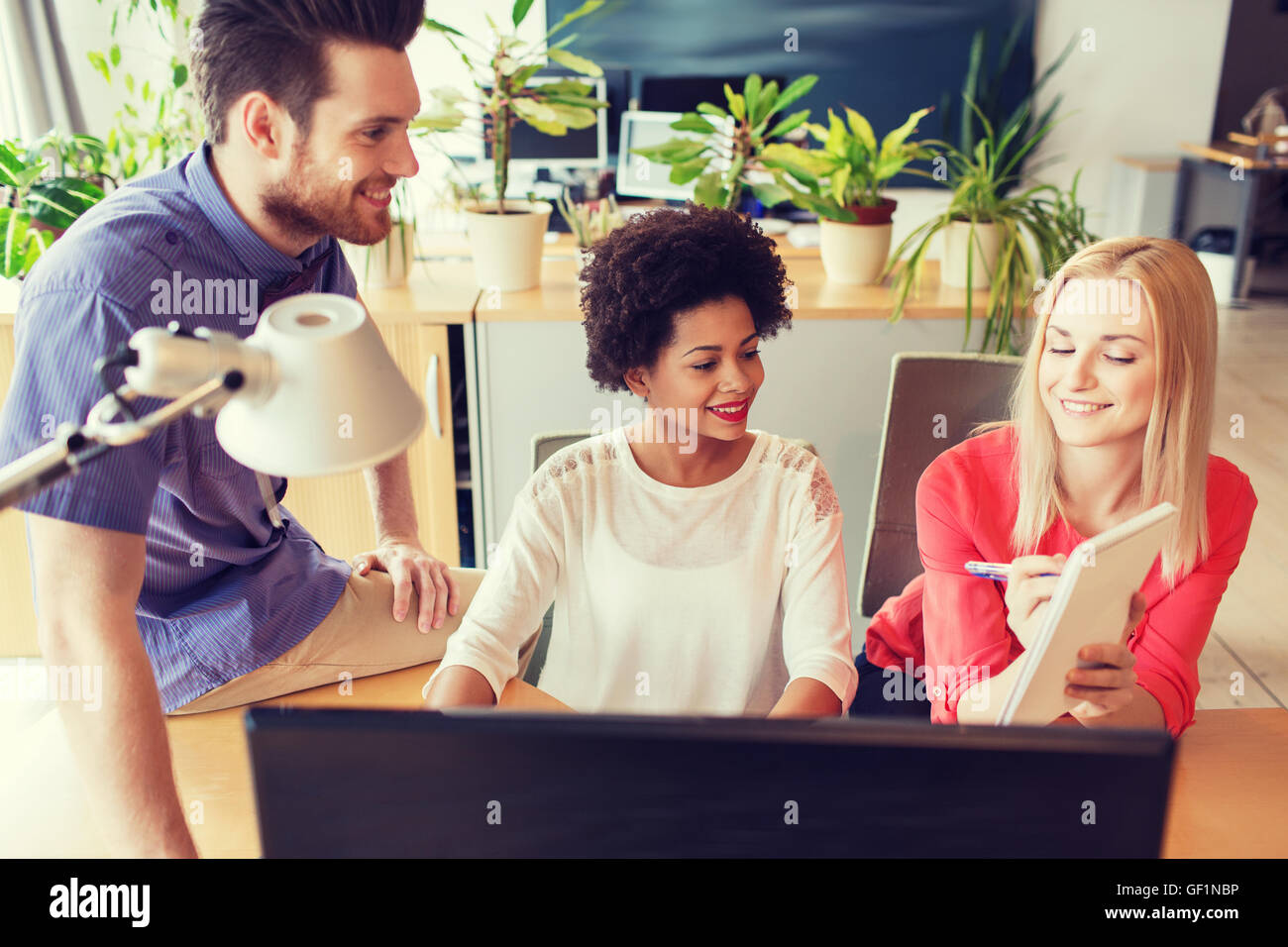 happy creative team with computer in office Stock Photo - Alamy