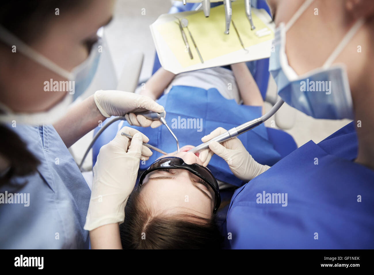 female dentists treating patient girl teeth Stock Photo - Alamy