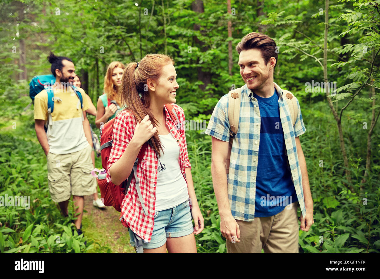 group of smiling friends with backpacks hiking Stock Photo - Alamy
