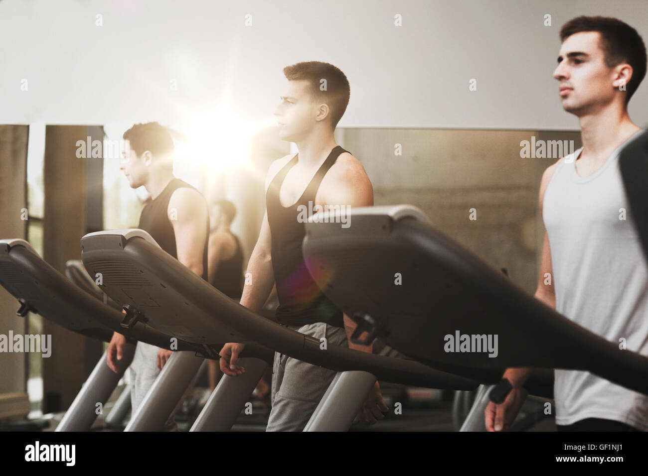 group of men exercising on treadmill in gym Stock Photo - Alamy