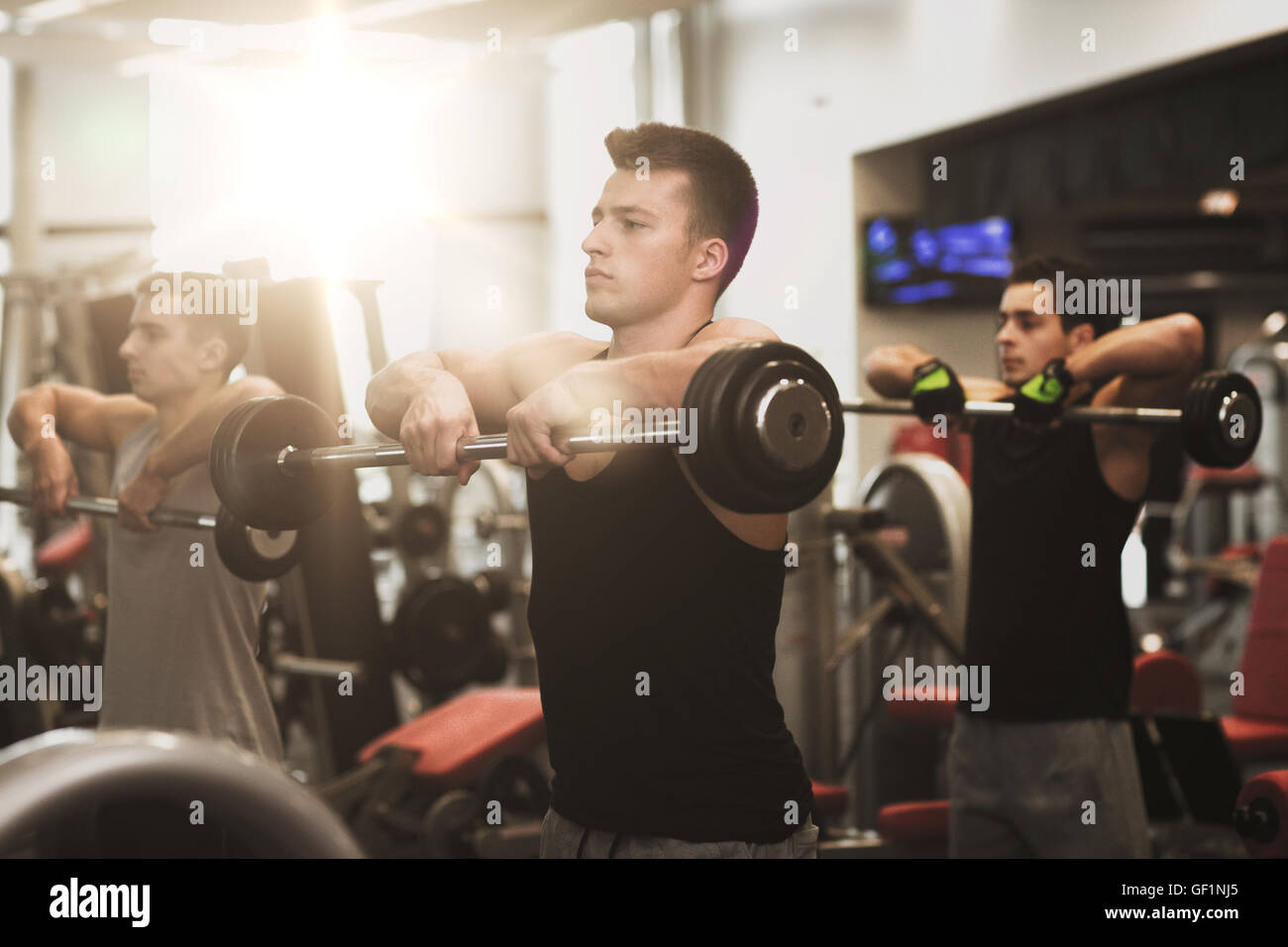 group of men with barbells in gym Stock Photo - Alamy