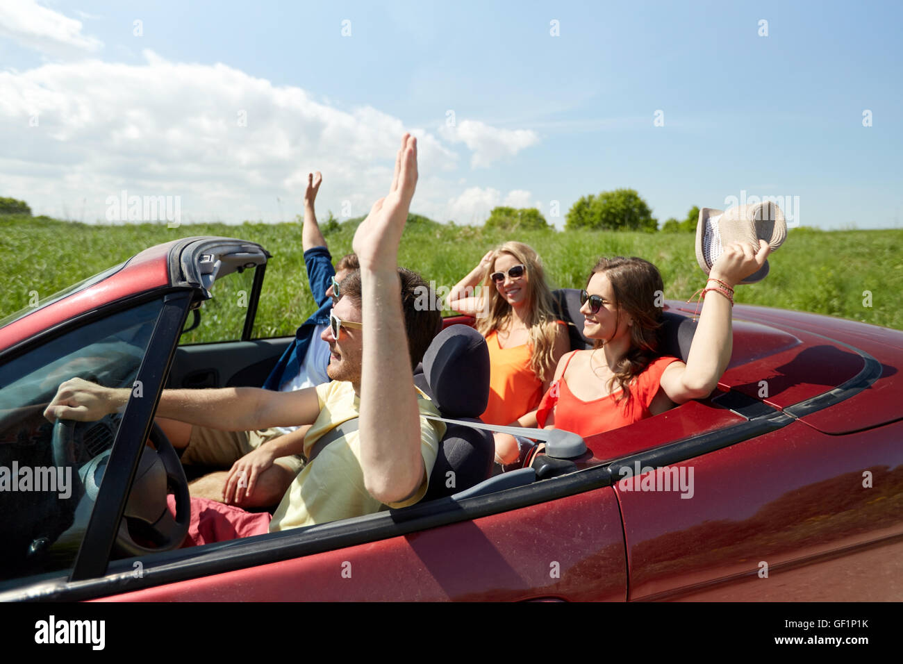happy friends driving in cabriolet car at country Stock Photo - Alamy