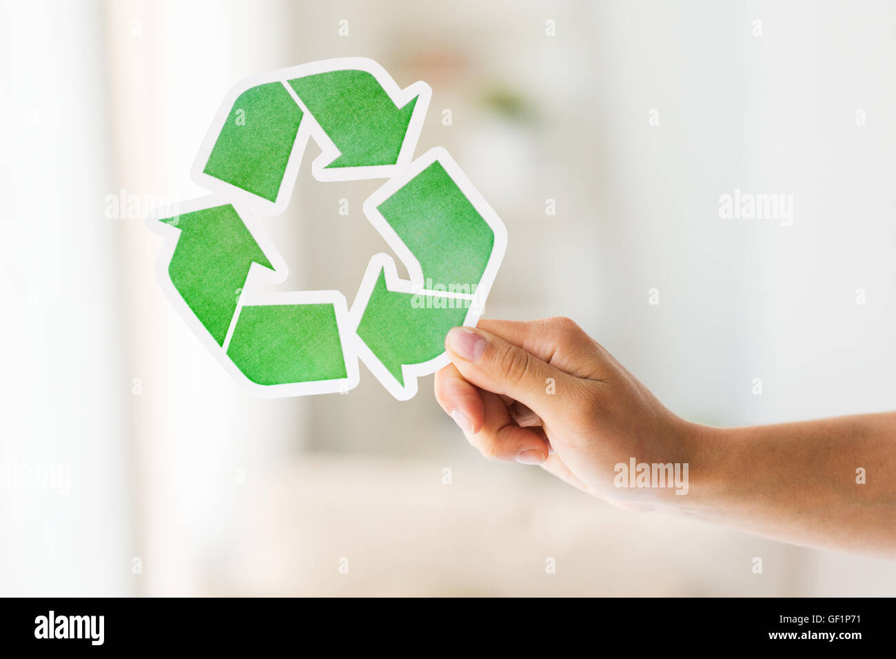 close up of hand holding green recycle symbol Stock Photo - Alamy