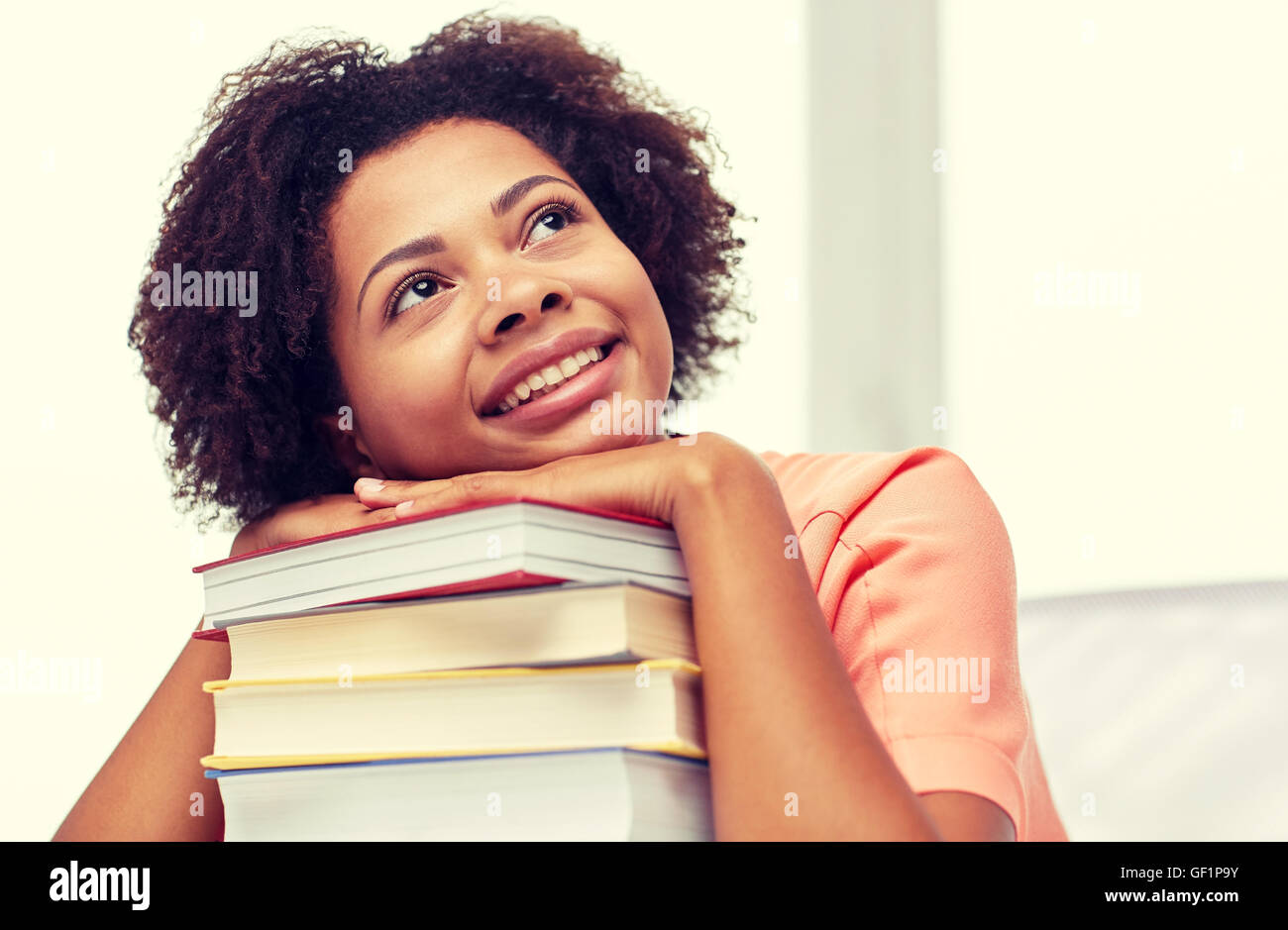 happy african student girl with books at home Stock Photo - Alamy